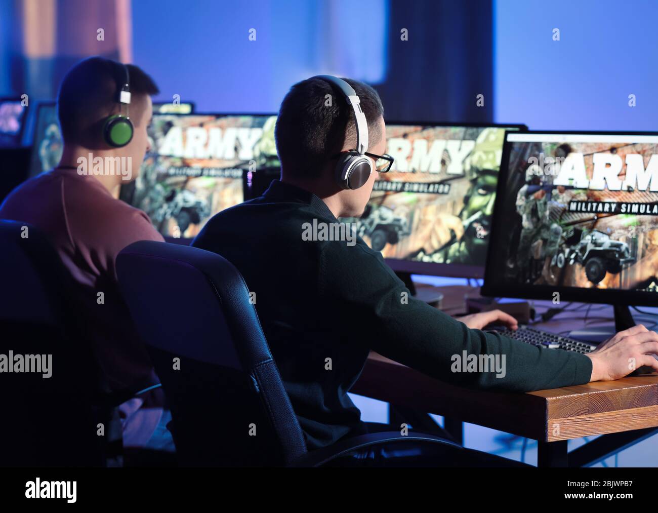 Young people playing video games at tournament Stock Photo - Alamy