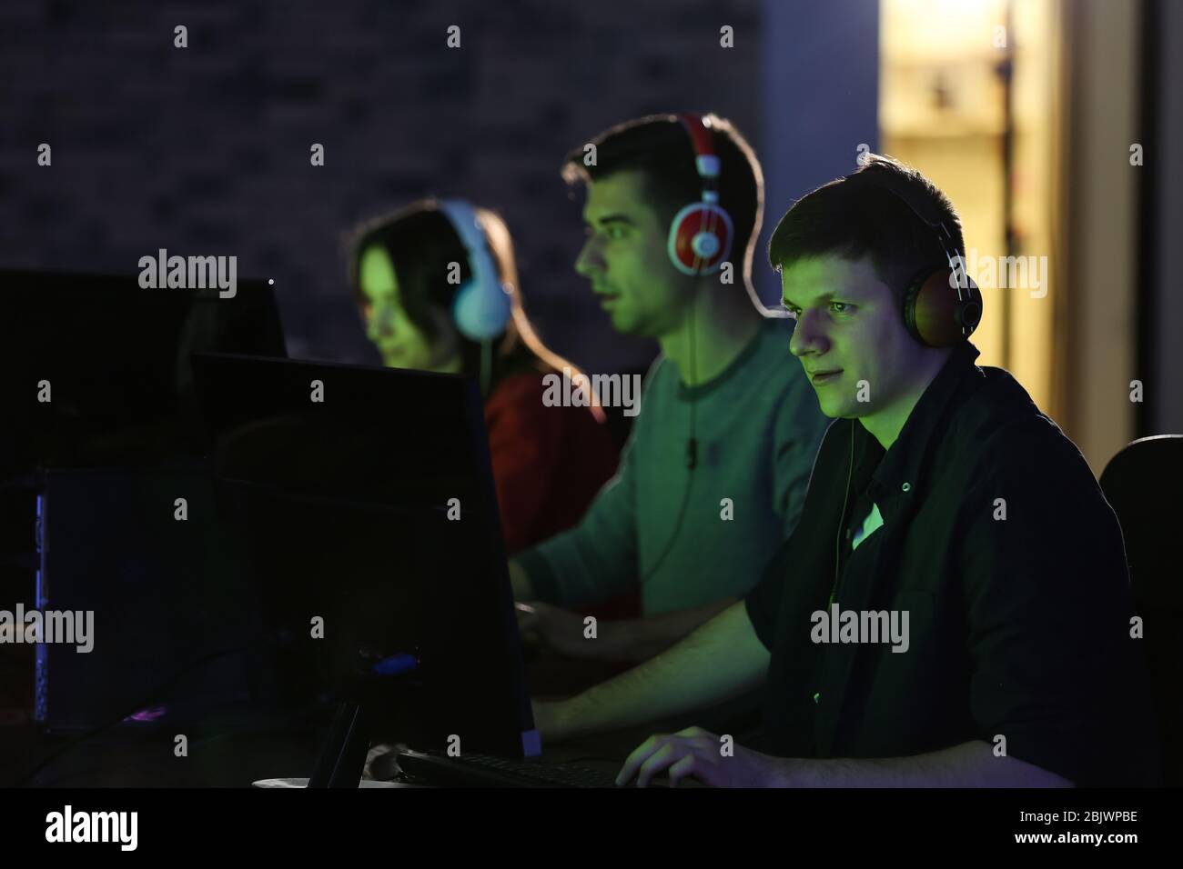 Young people playing video games at tournament Stock Photo - Alamy