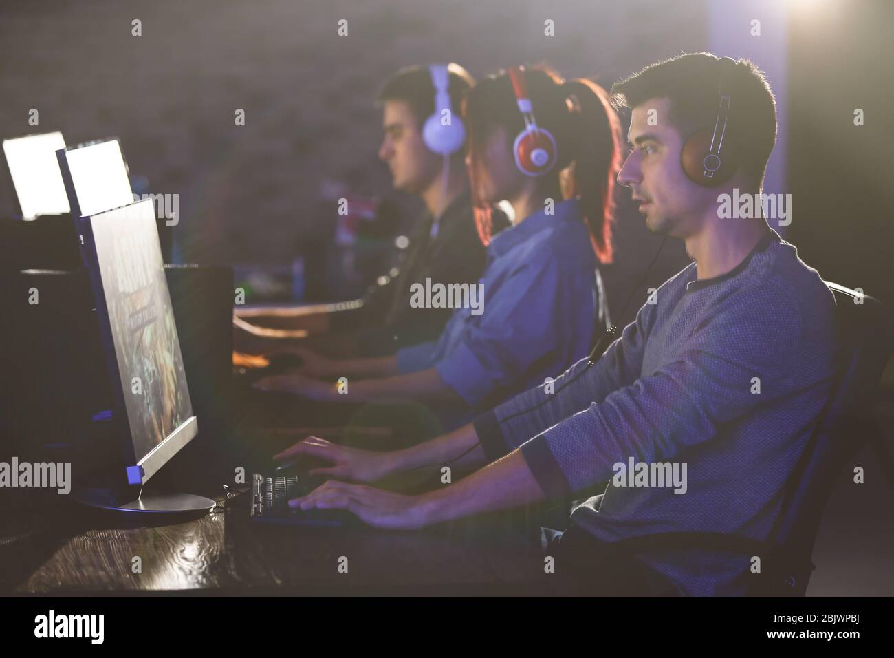 Young people playing video games at tournament Stock Photo - Alamy