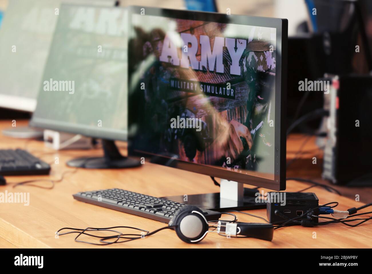 Table with computers for video games tournament Stock Photo - Alamy