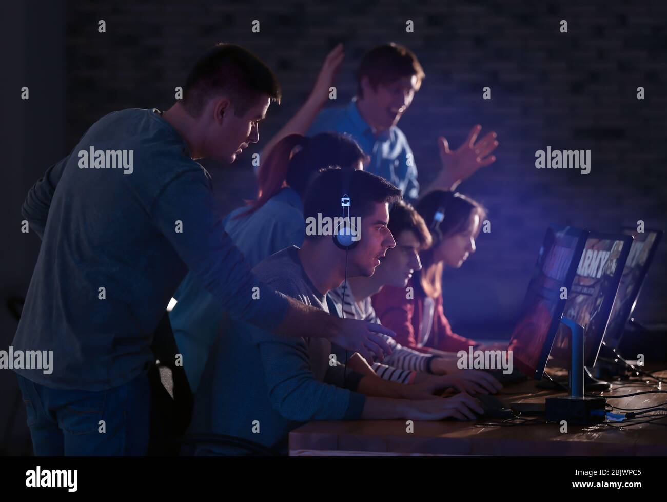 Young people playing video games at tournament Stock Photo - Alamy