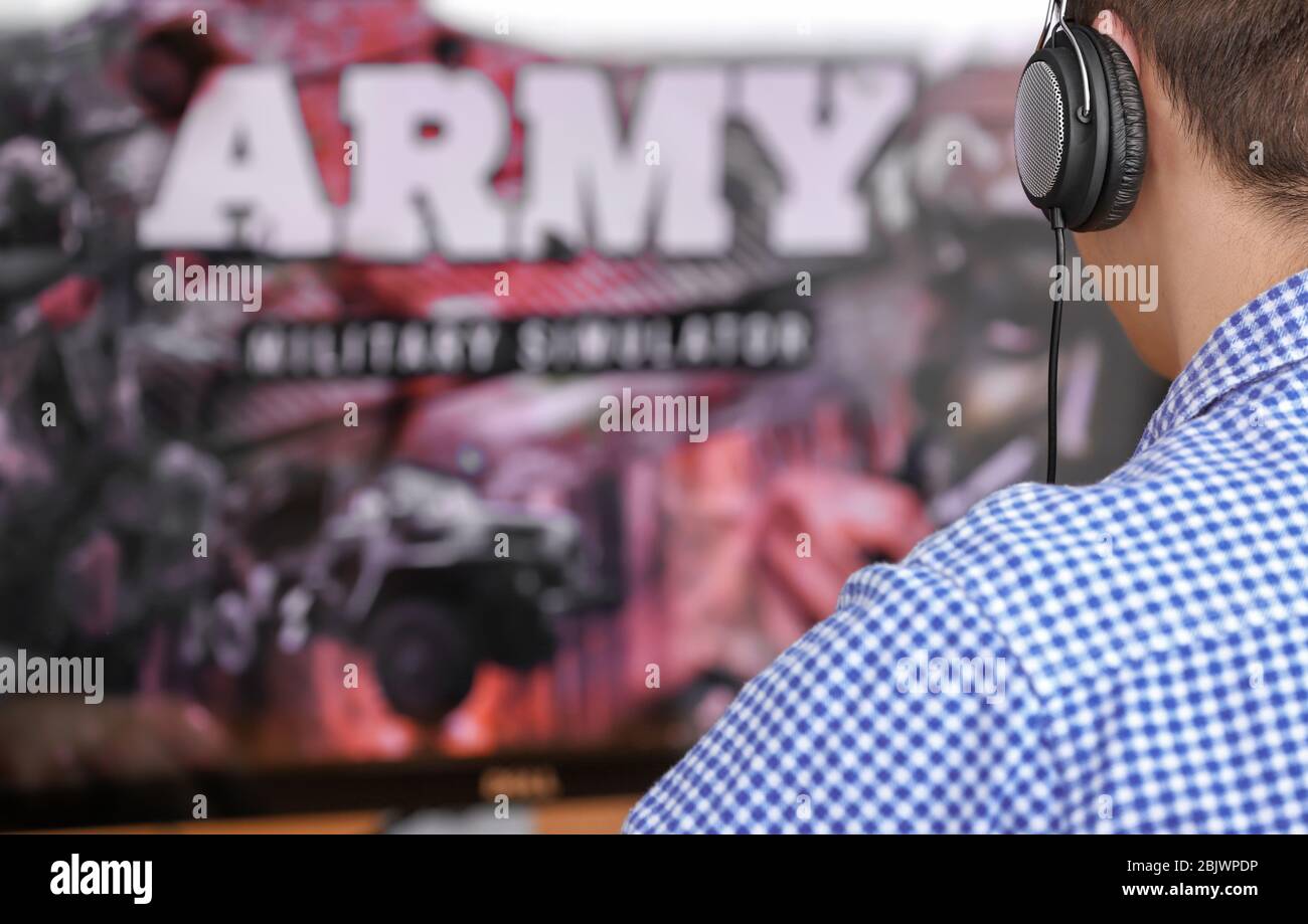 Young man playing video games at tournament Stock Photo - Alamy