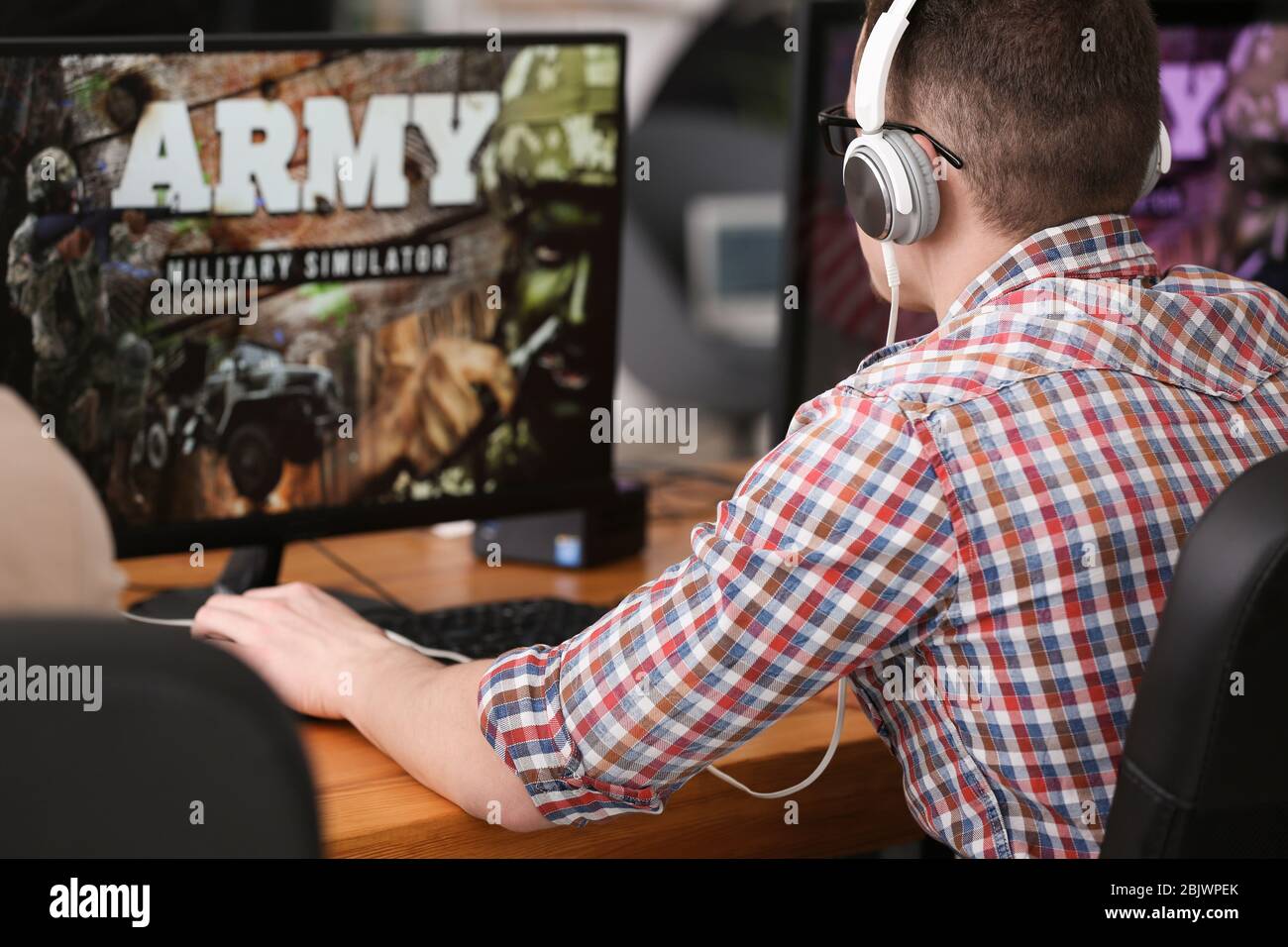 Young man playing video games at tournament Stock Photo - Alamy