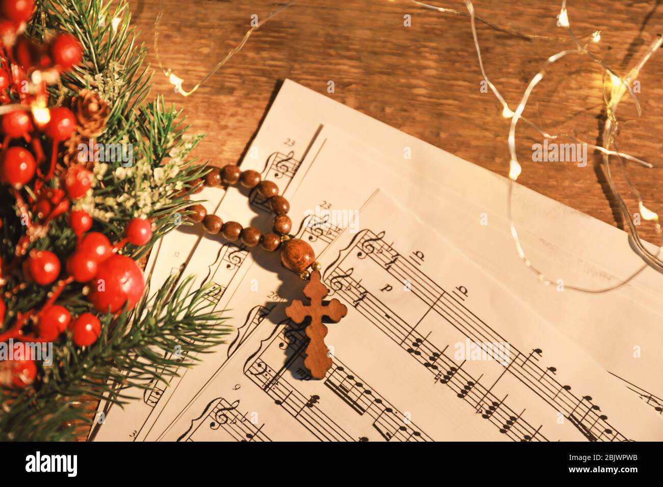 Christmas composition with wooden cross and music sheets on table Stock ...