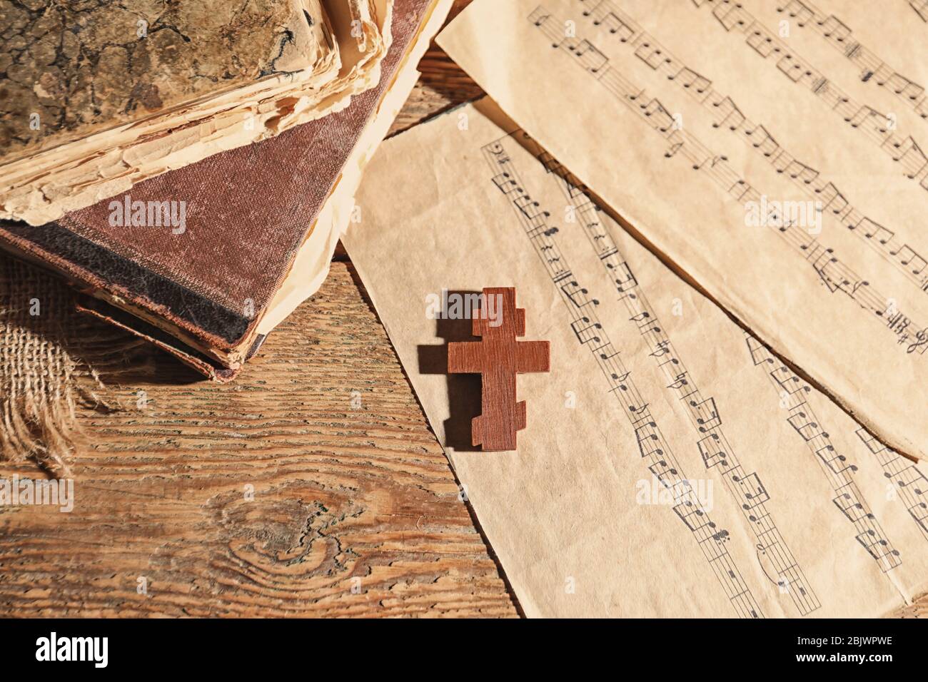 Wooden cross on music sheet Stock Photo - Alamy