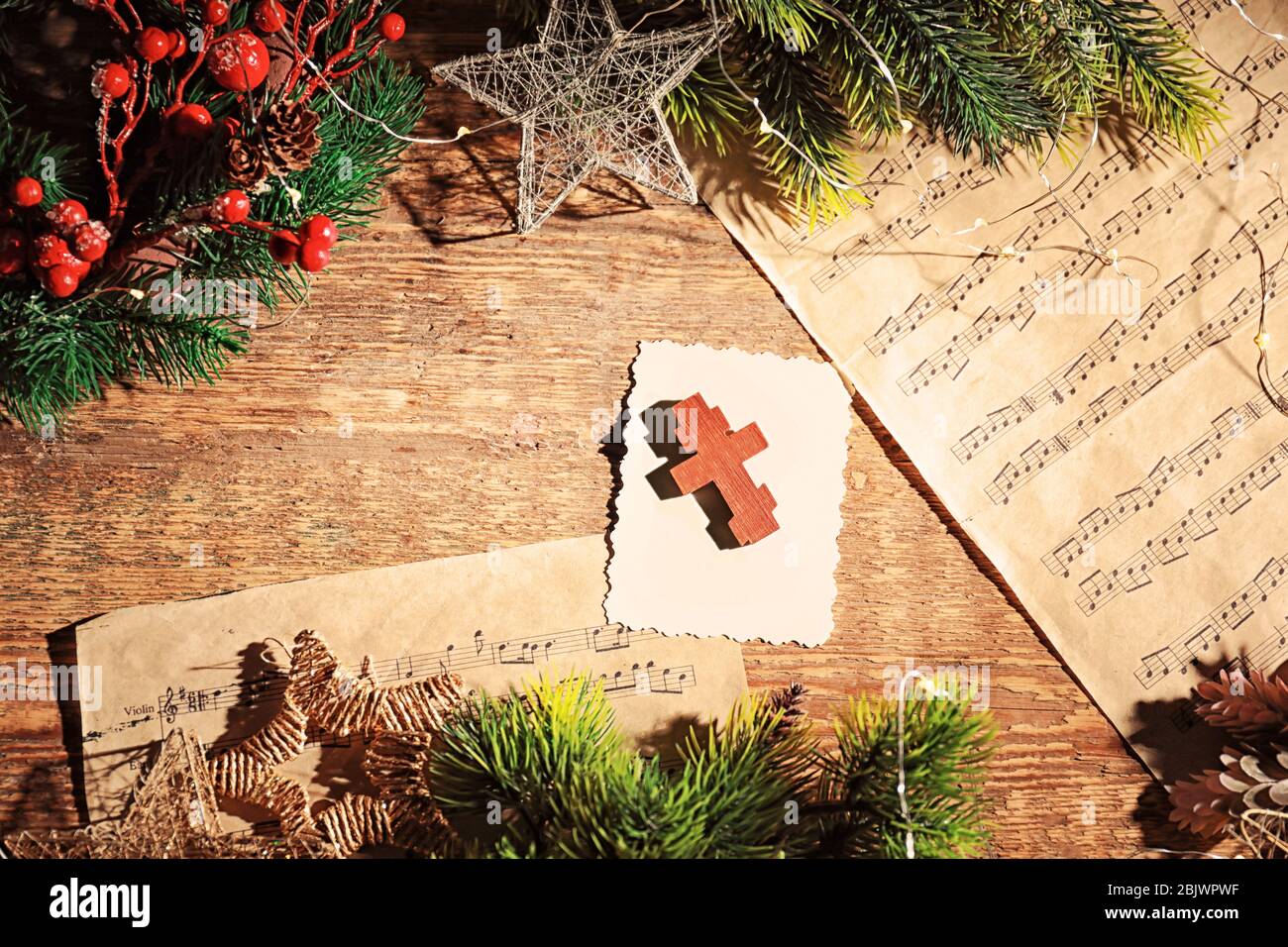 Christmas composition with cross and fir tree branches on wooden ...