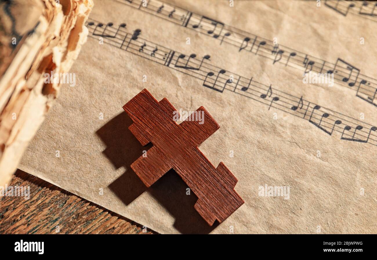 Wooden cross on music sheet Stock Photo - Alamy