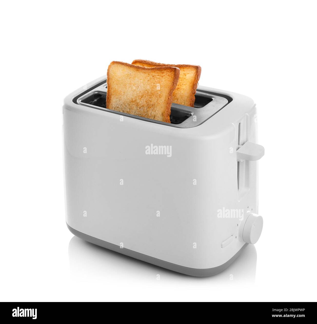Preparing bread in toaster on white background Stock Photo - Alamy