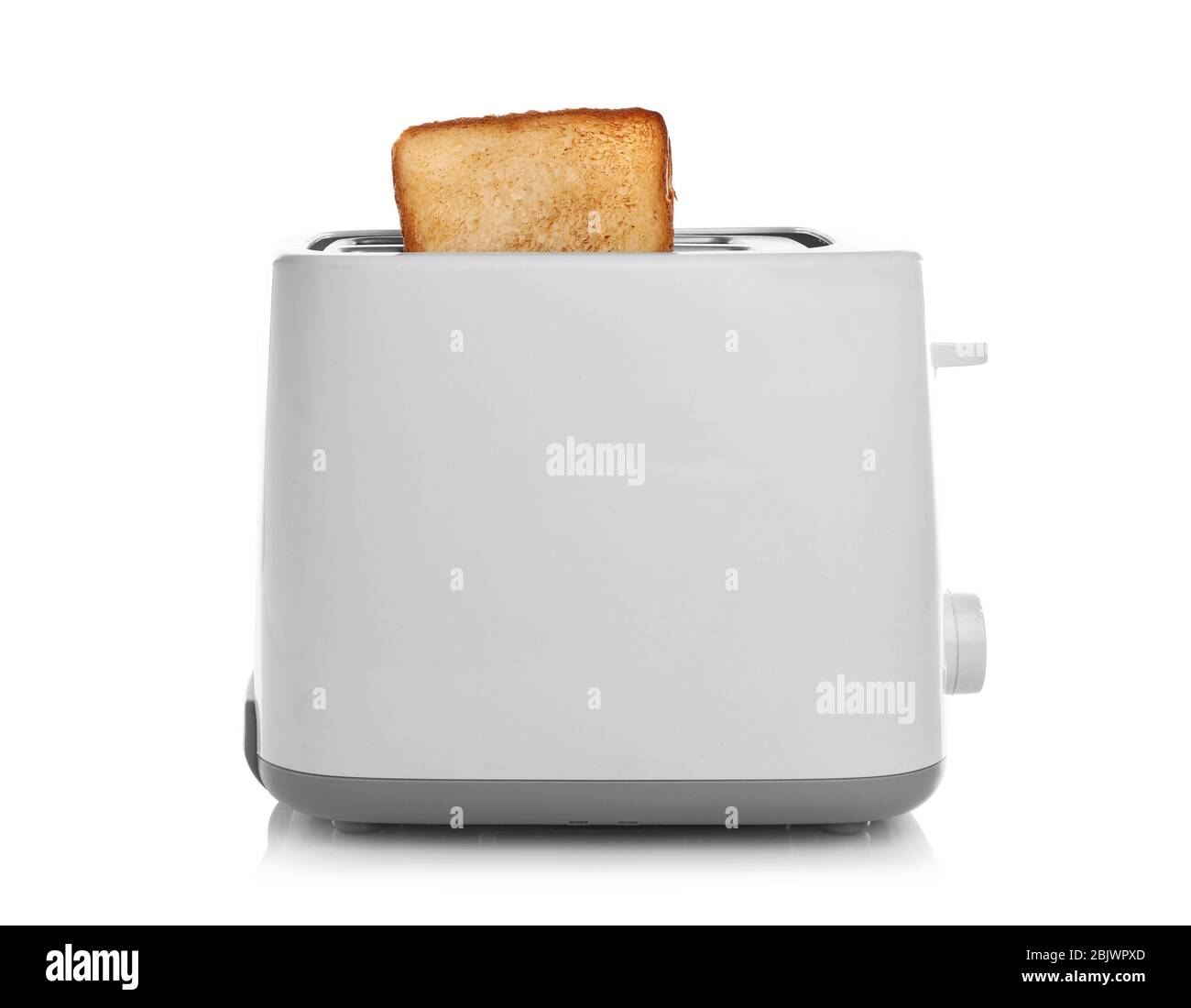 Preparing bread in toaster on white background Stock Photo - Alamy