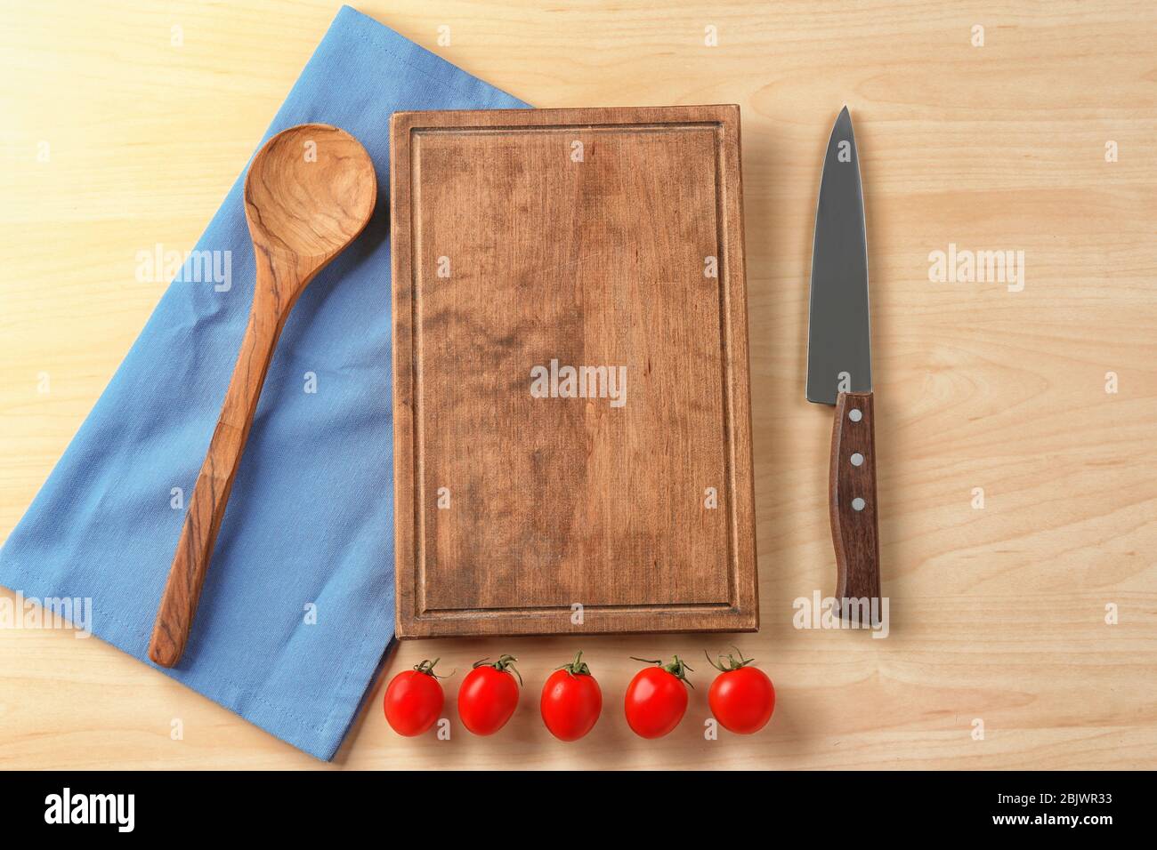 Kitchen utensils and tomatoes on wooden background. Cooking master ...