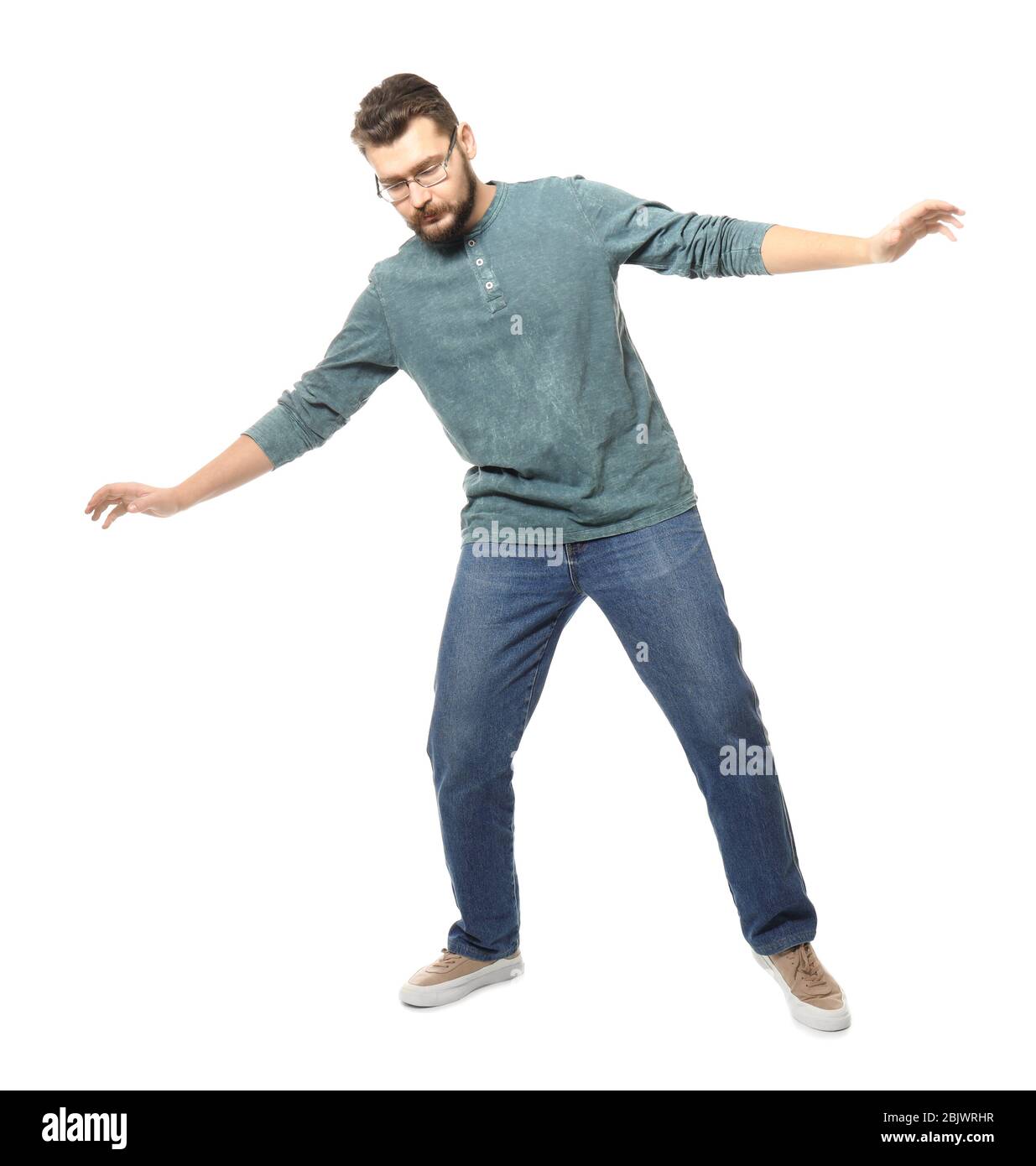 Young man balancing on white background Stock Photo - Alamy
