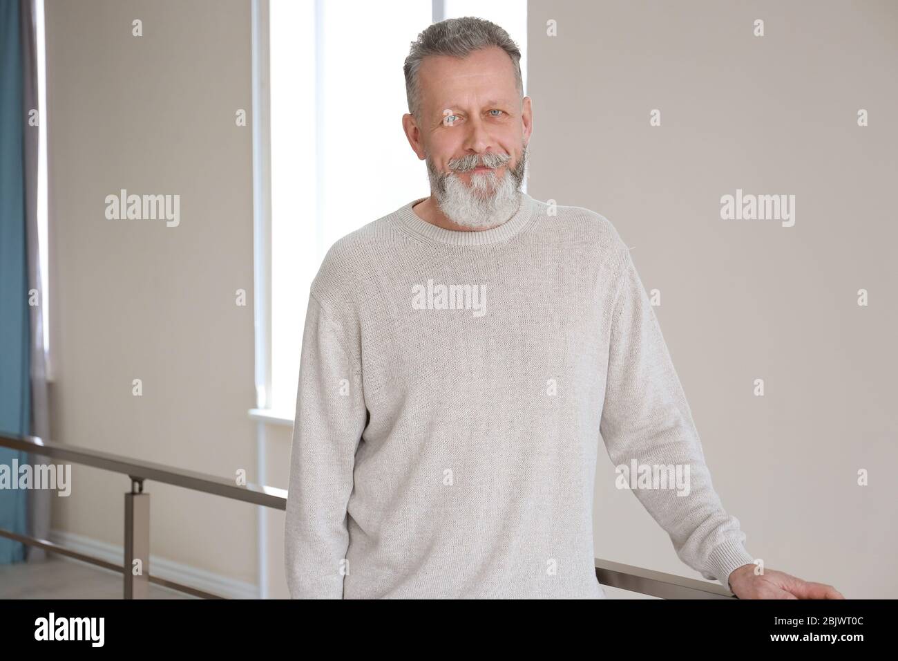 Portrait of confident mature man indoors Stock Photo - Alamy
