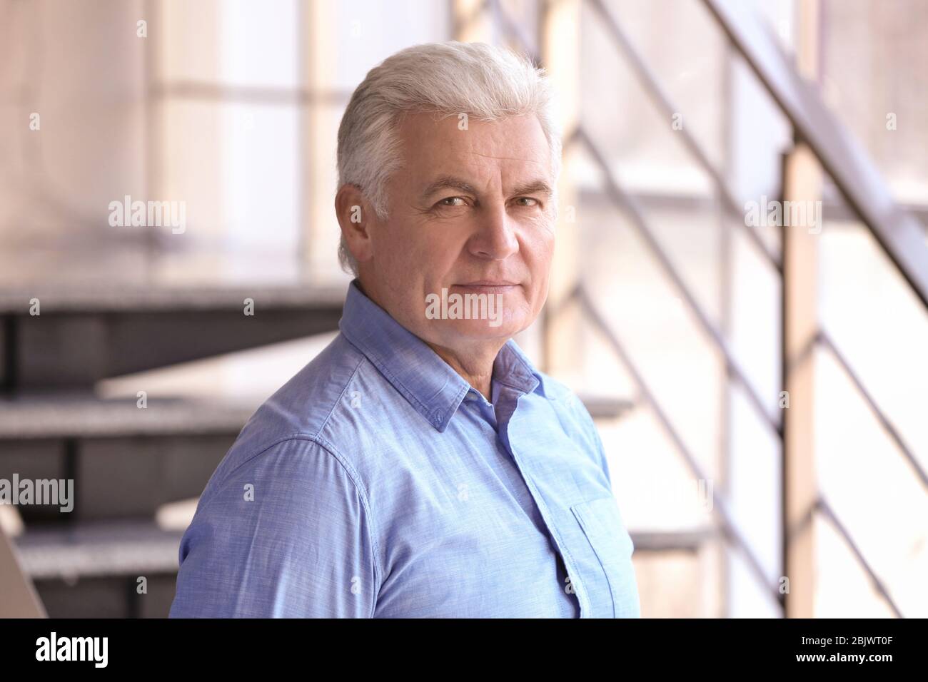 Portrait of confident mature man indoors Stock Photo - Alamy