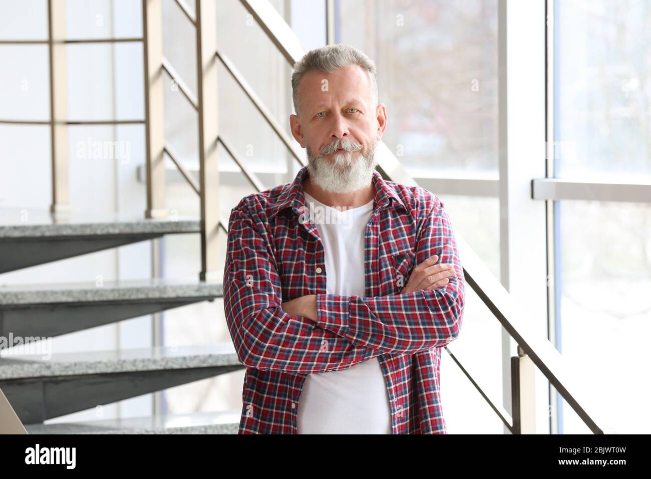Portrait of confident mature man indoors Stock Photo - Alamy