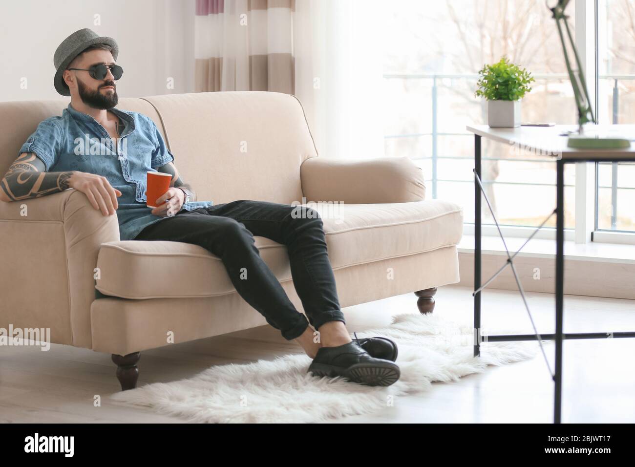Portrait of handsome hipster in stylish outfit indoors Stock Photo - Alamy