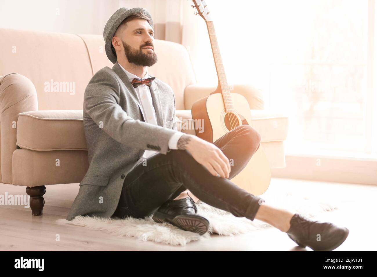 Portrait of handsome hipster in stylish outfit indoors Stock Photo - Alamy