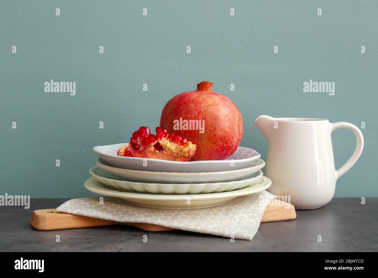 Set of dishware with fruit on table Stock Photo - Alamy