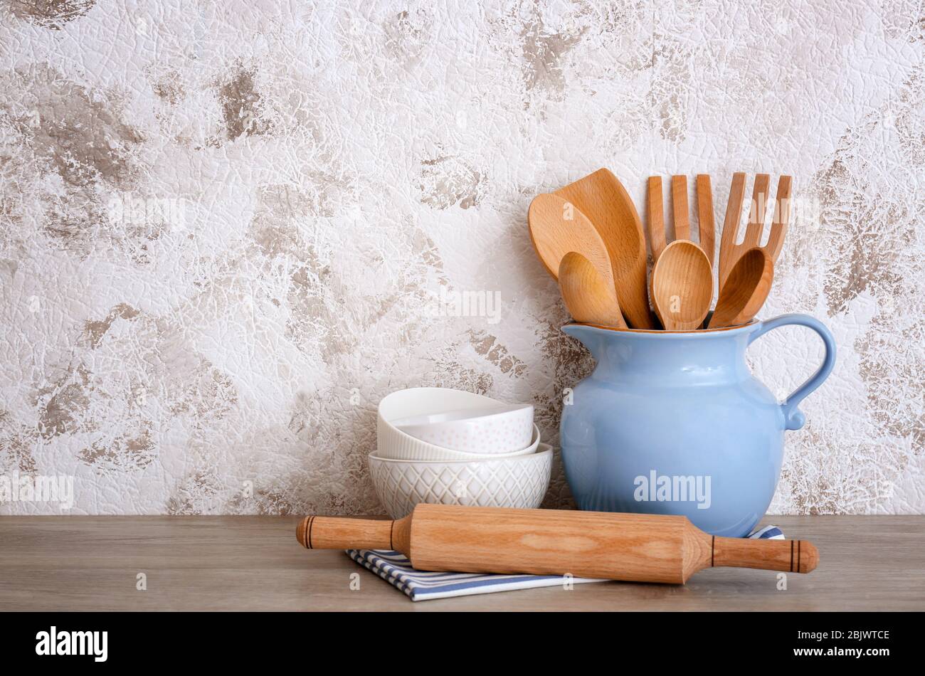 Set of cooking utensils and dishware on table Stock Photo - Alamy