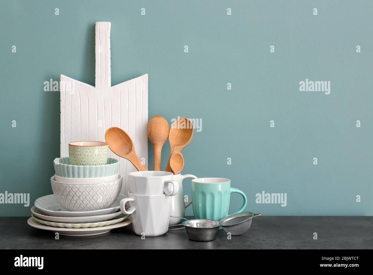 Set of cooking utensils and dishware on table Stock Photo - Alamy
