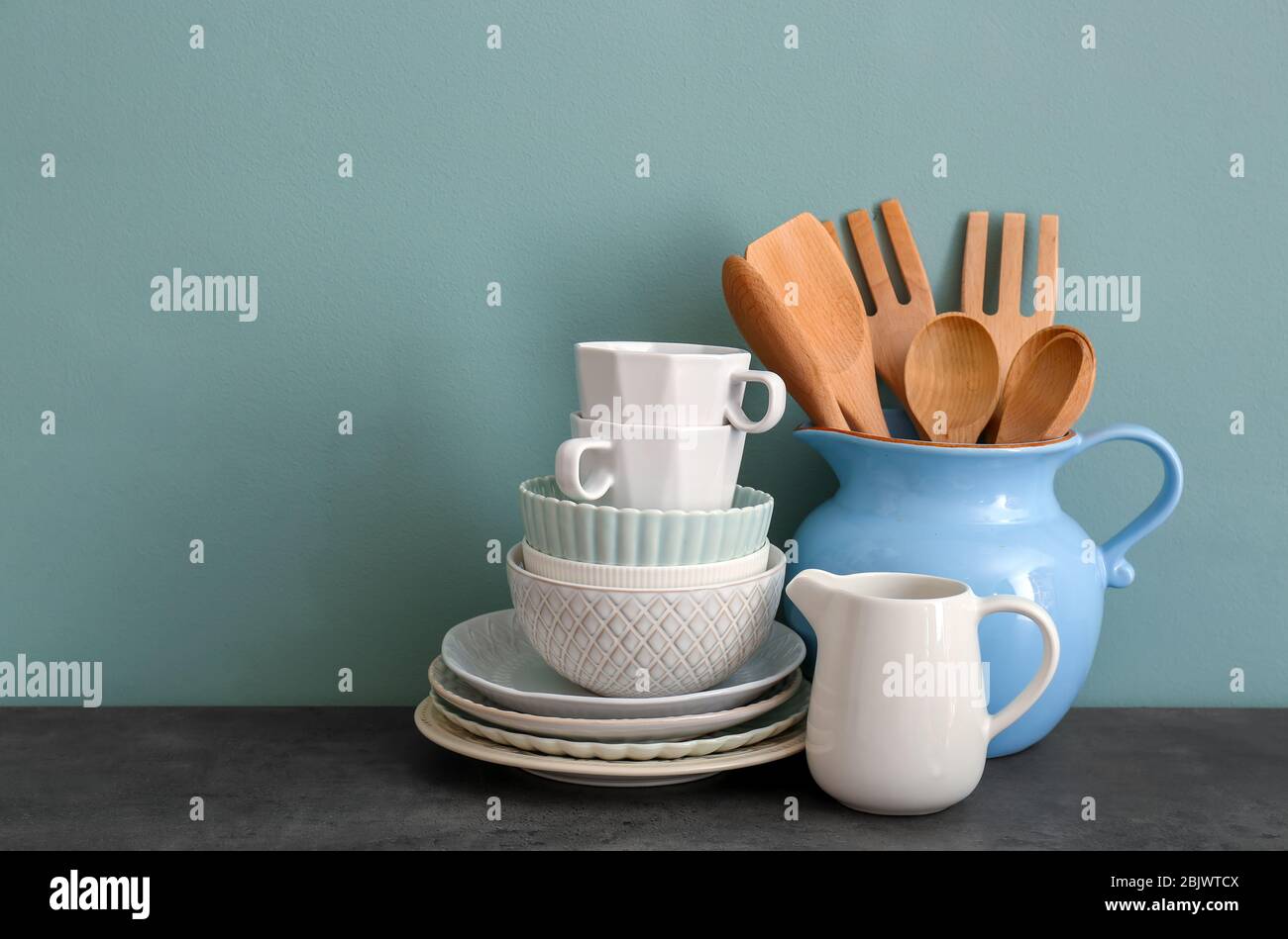 Set of cooking utensils and dishware on table Stock Photo - Alamy