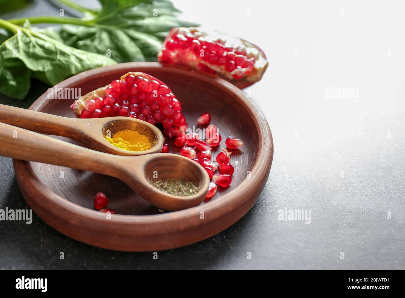 Plate with spoons and products on table Stock Photo - Alamy