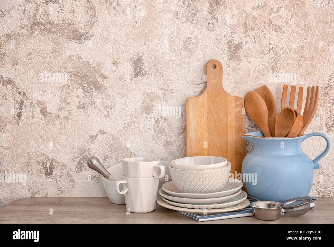 Set of cooking utensils and dishware on table Stock Photo - Alamy