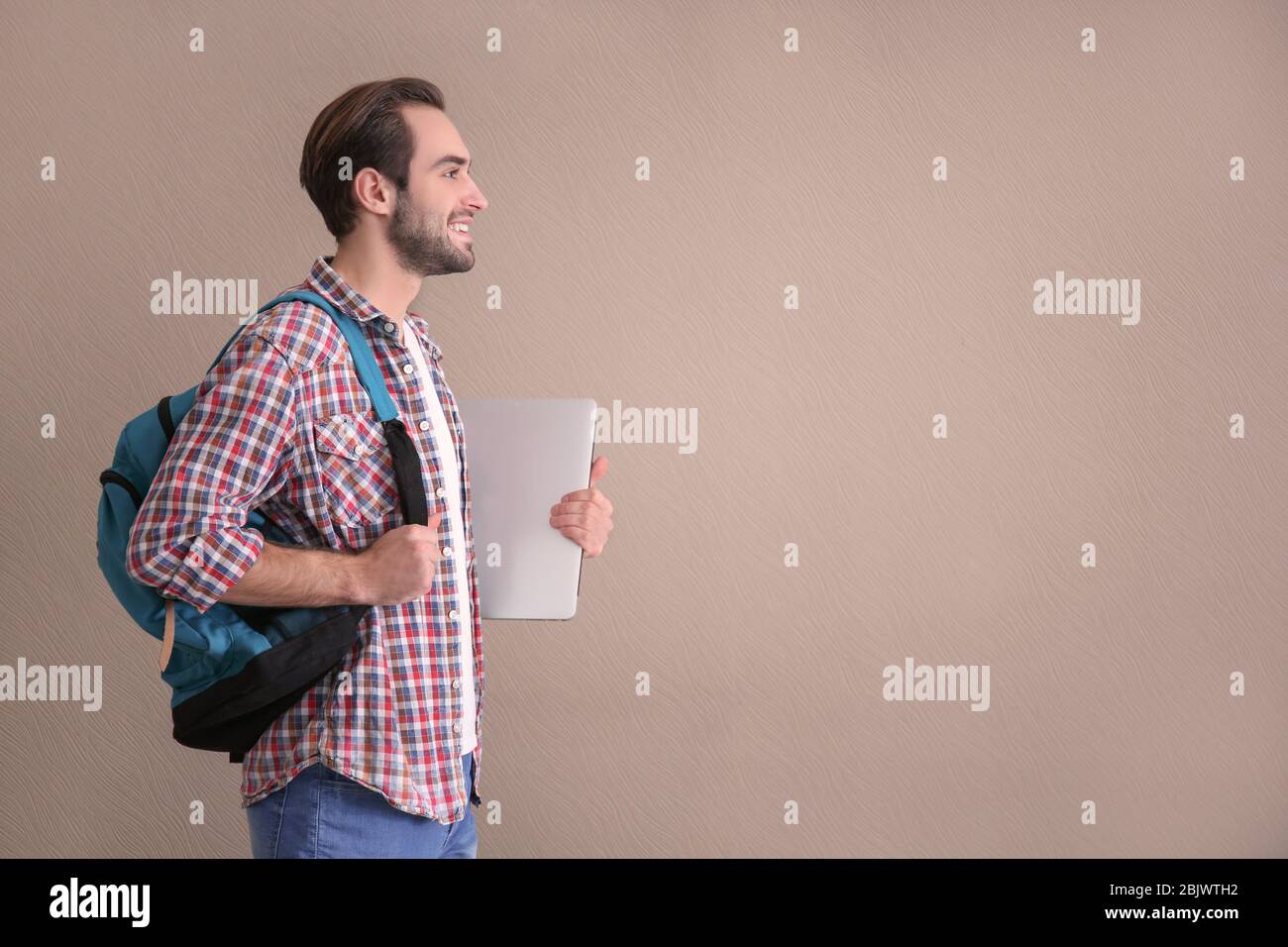 Student with laptop on color background Stock Photo - Alamy
