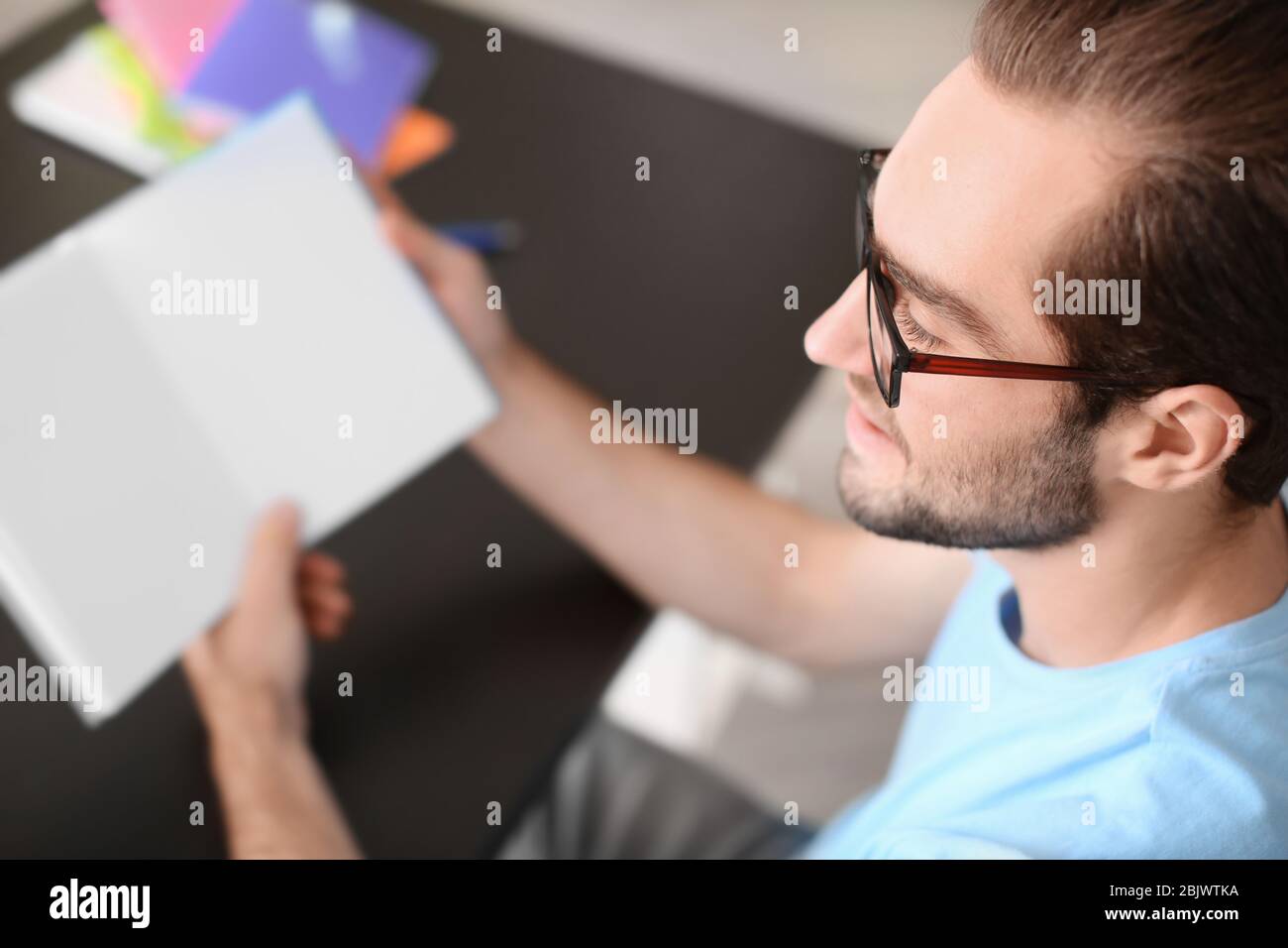 Student studying at table indoors Stock Photo - Alamy