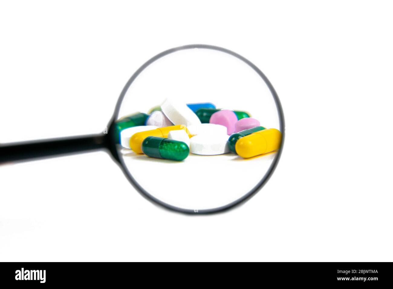 Zooming pills using magnifier glass. Special unique pills isolated on ...