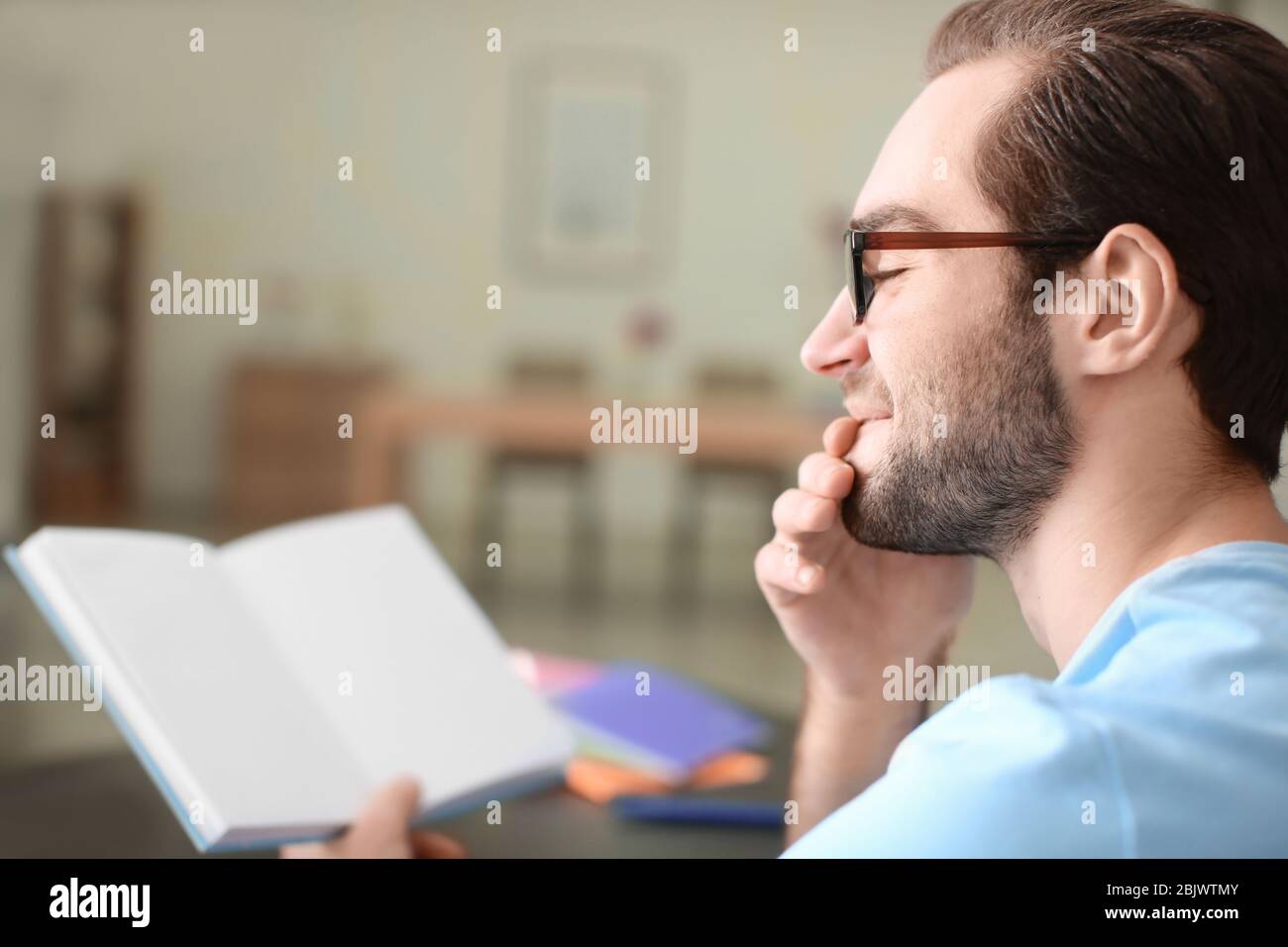 Student studying at table indoors Stock Photo - Alamy