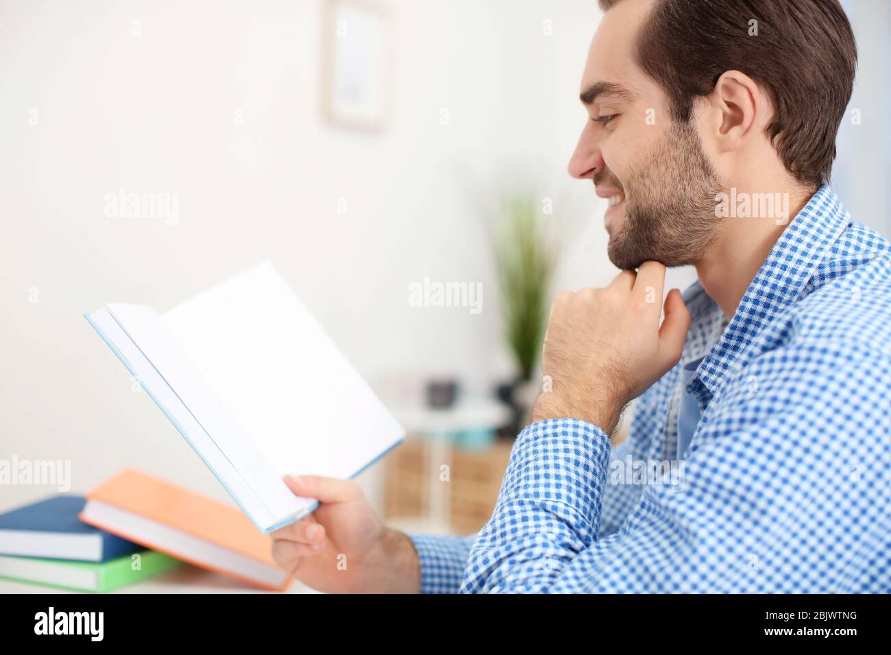 Student studying at table indoors Stock Photo - Alamy