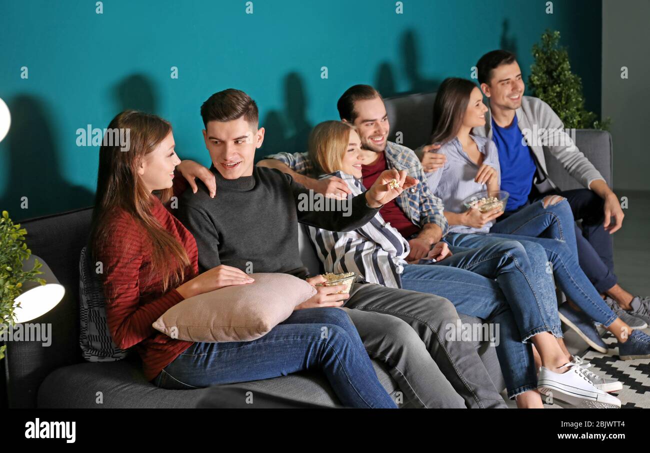 Young people watching movie in home cinema at night Stock Photo - Alamy