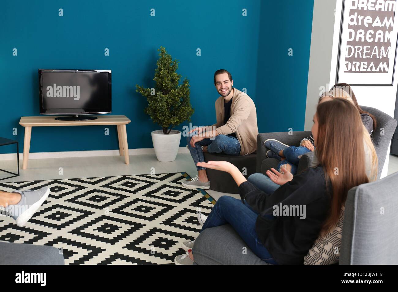Young people watching movie in home cinema Stock Photo - Alamy