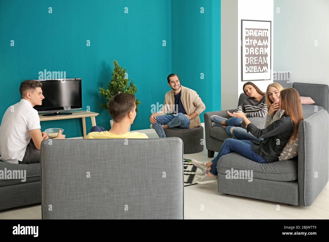 Young people watching movie in home cinema Stock Photo - Alamy