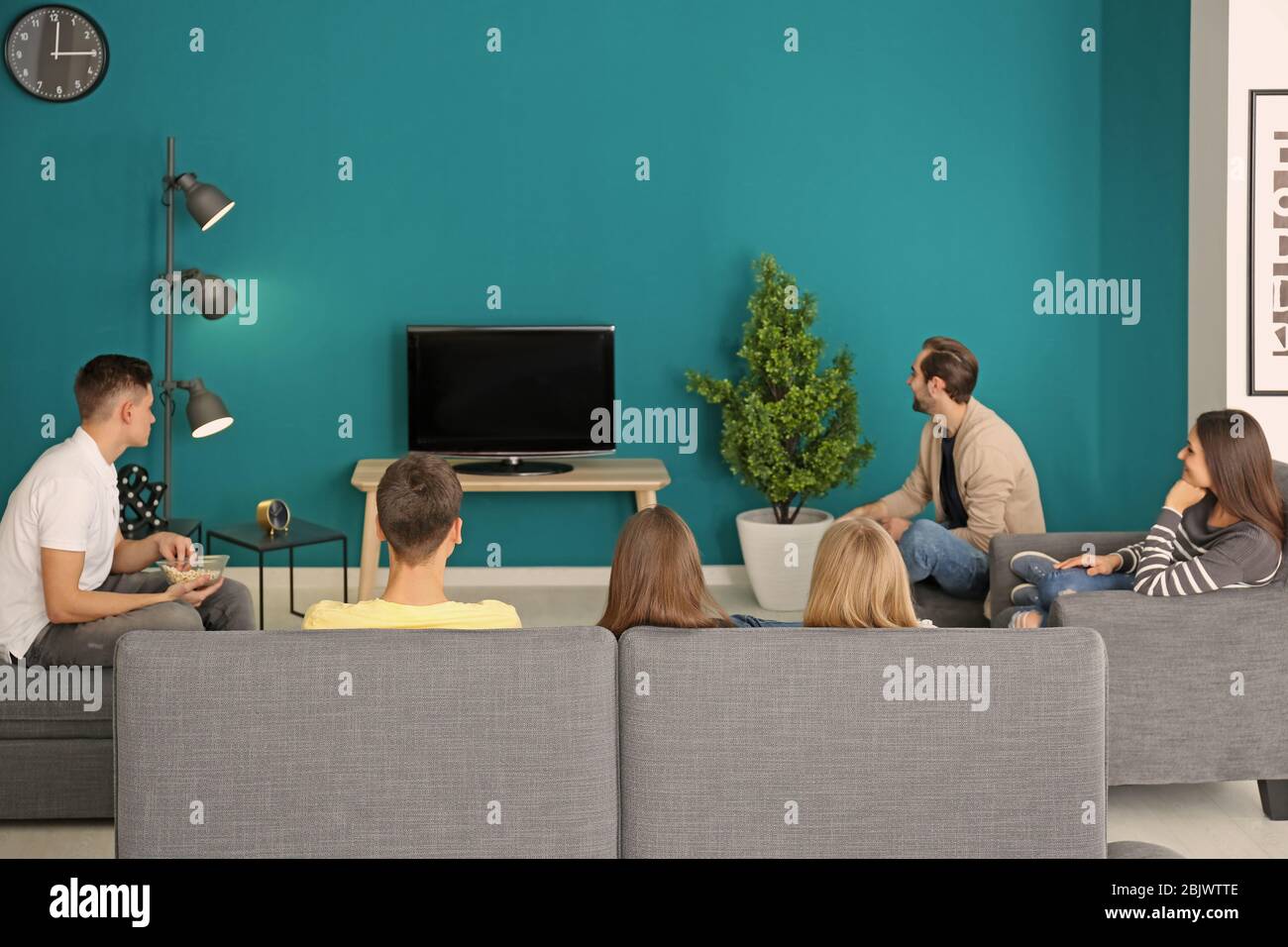 Young people watching movie in home cinema Stock Photo - Alamy