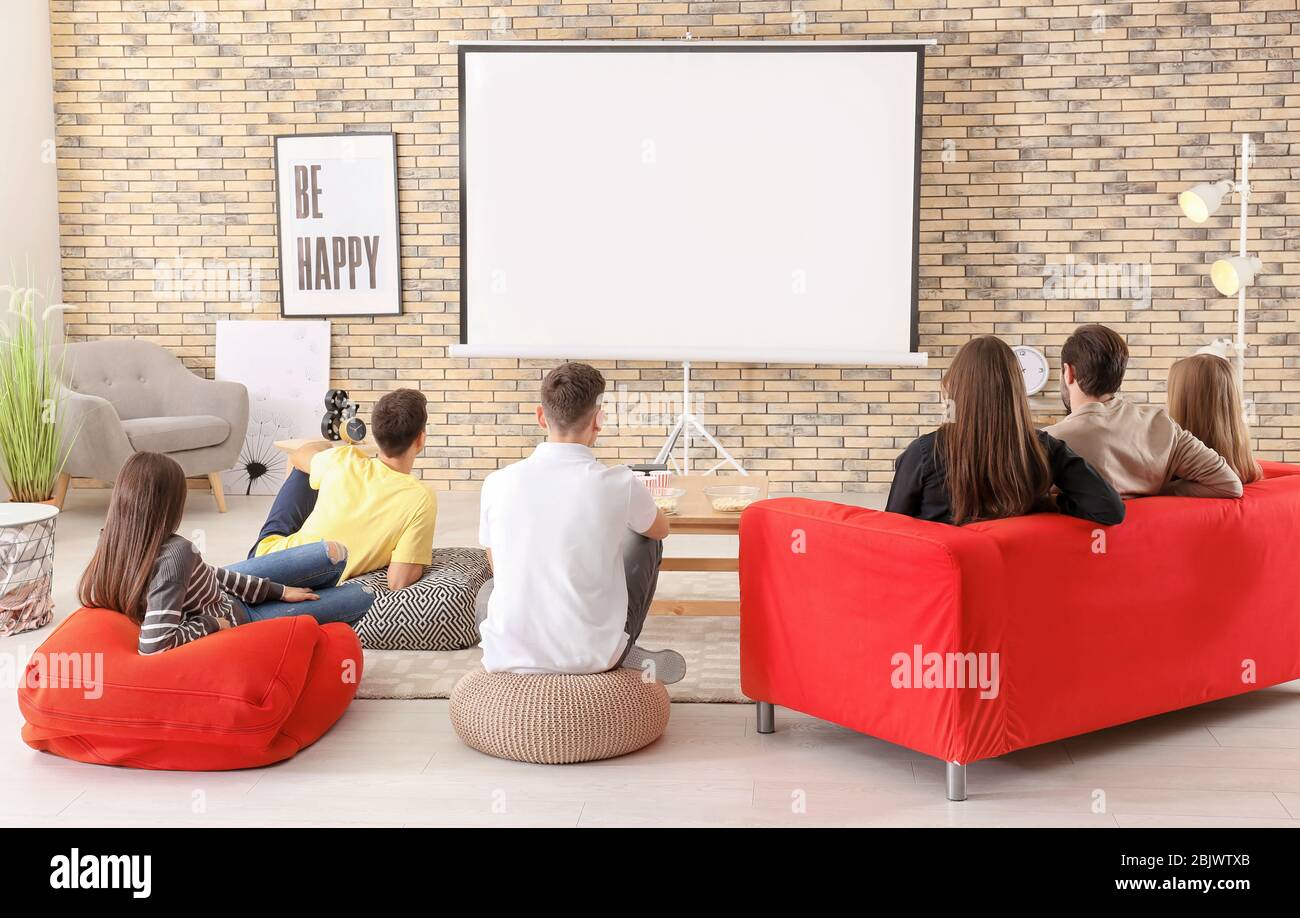 Young people watching movie in home cinema Stock Photo - Alamy