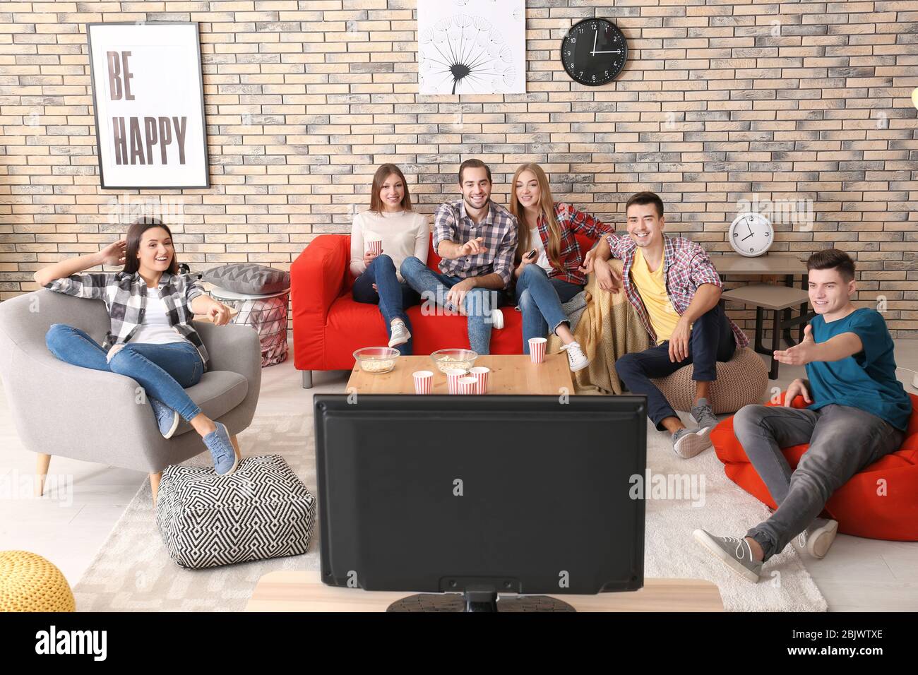 Young people watching movie in home cinema Stock Photo - Alamy