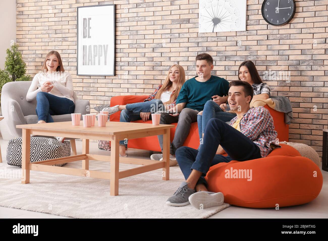 Young people watching movie in home cinema Stock Photo - Alamy