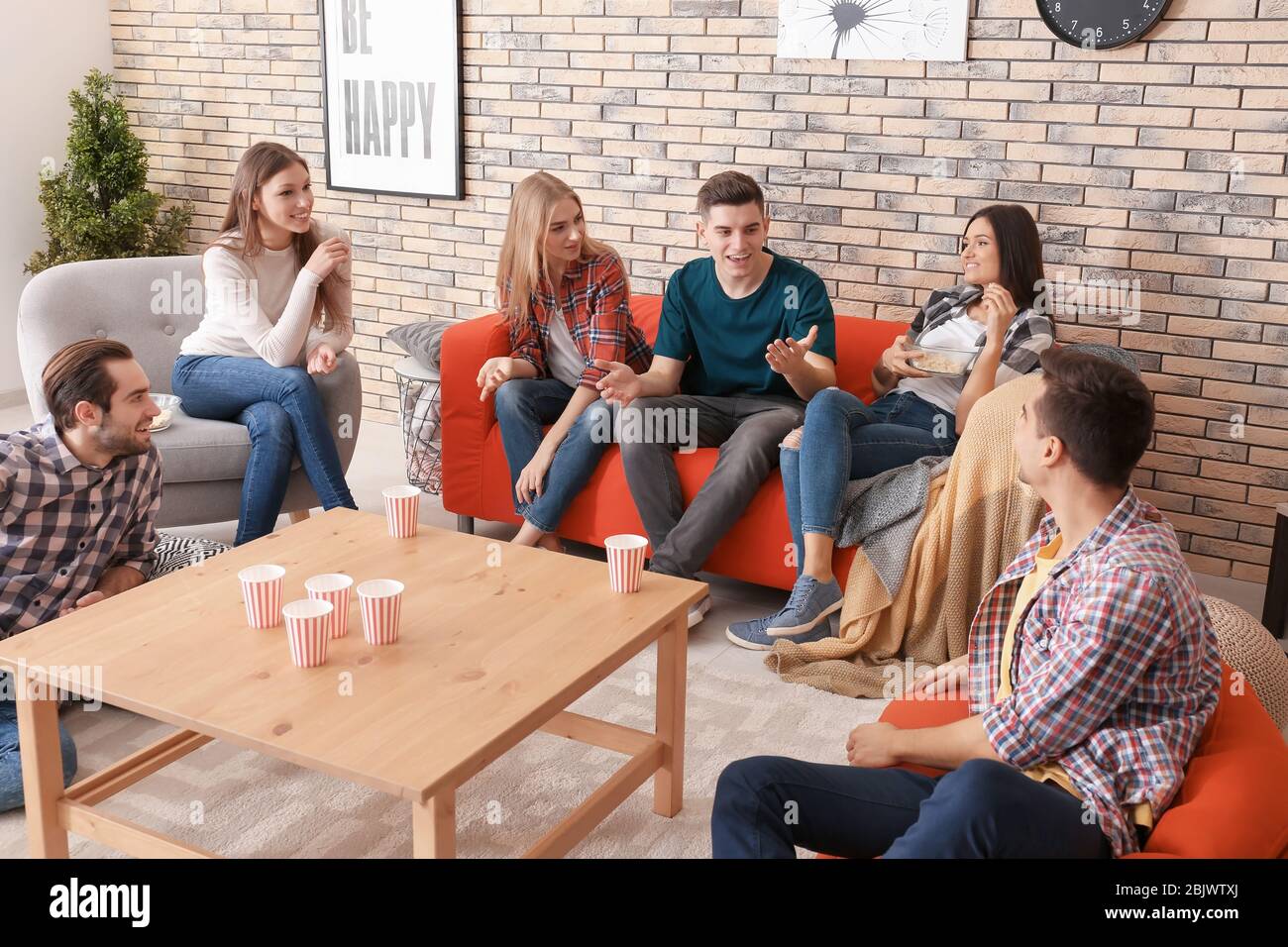 Young people watching and discussing movie in home cinema Stock Photo ...