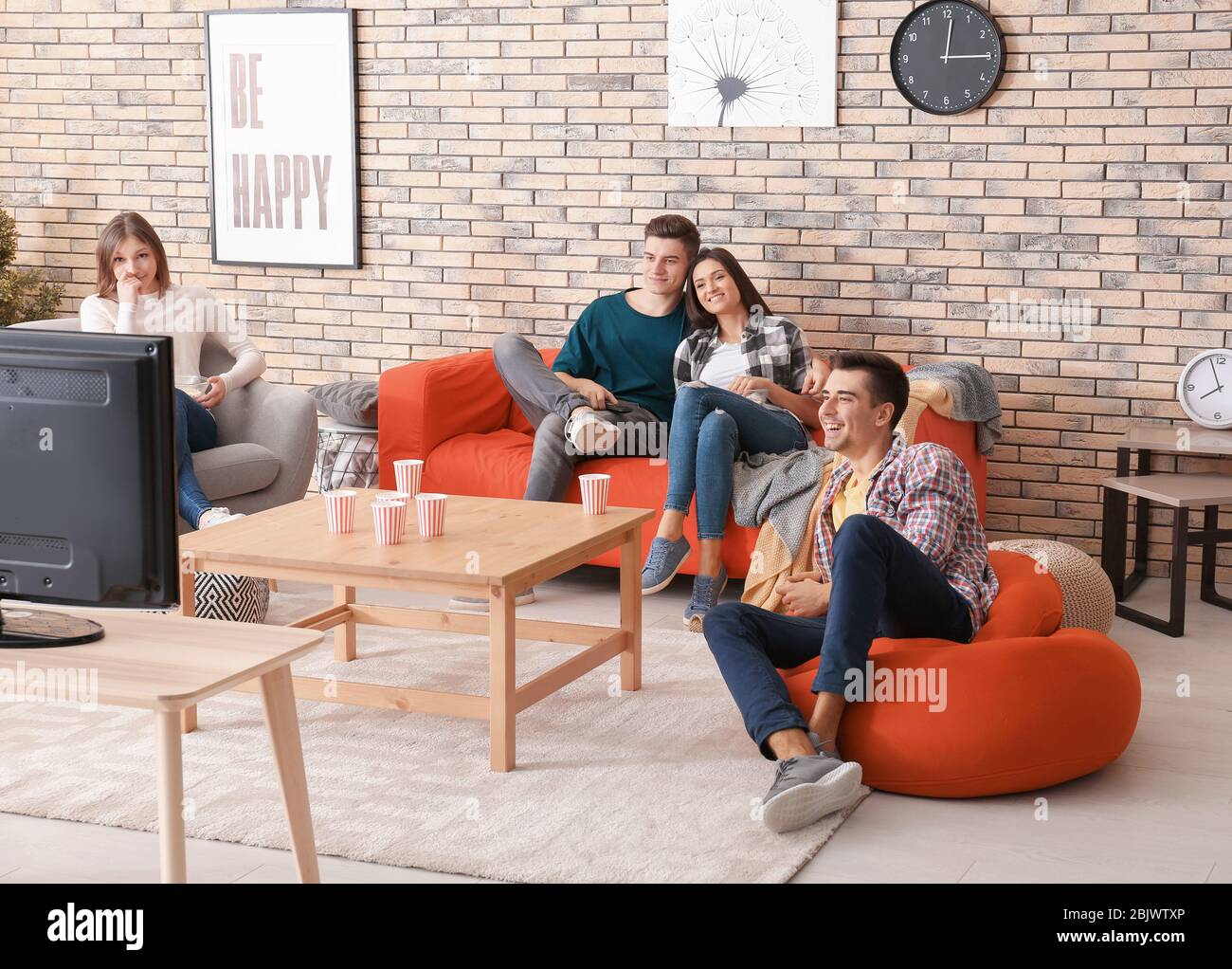 Young people watching movie in home cinema Stock Photo - Alamy