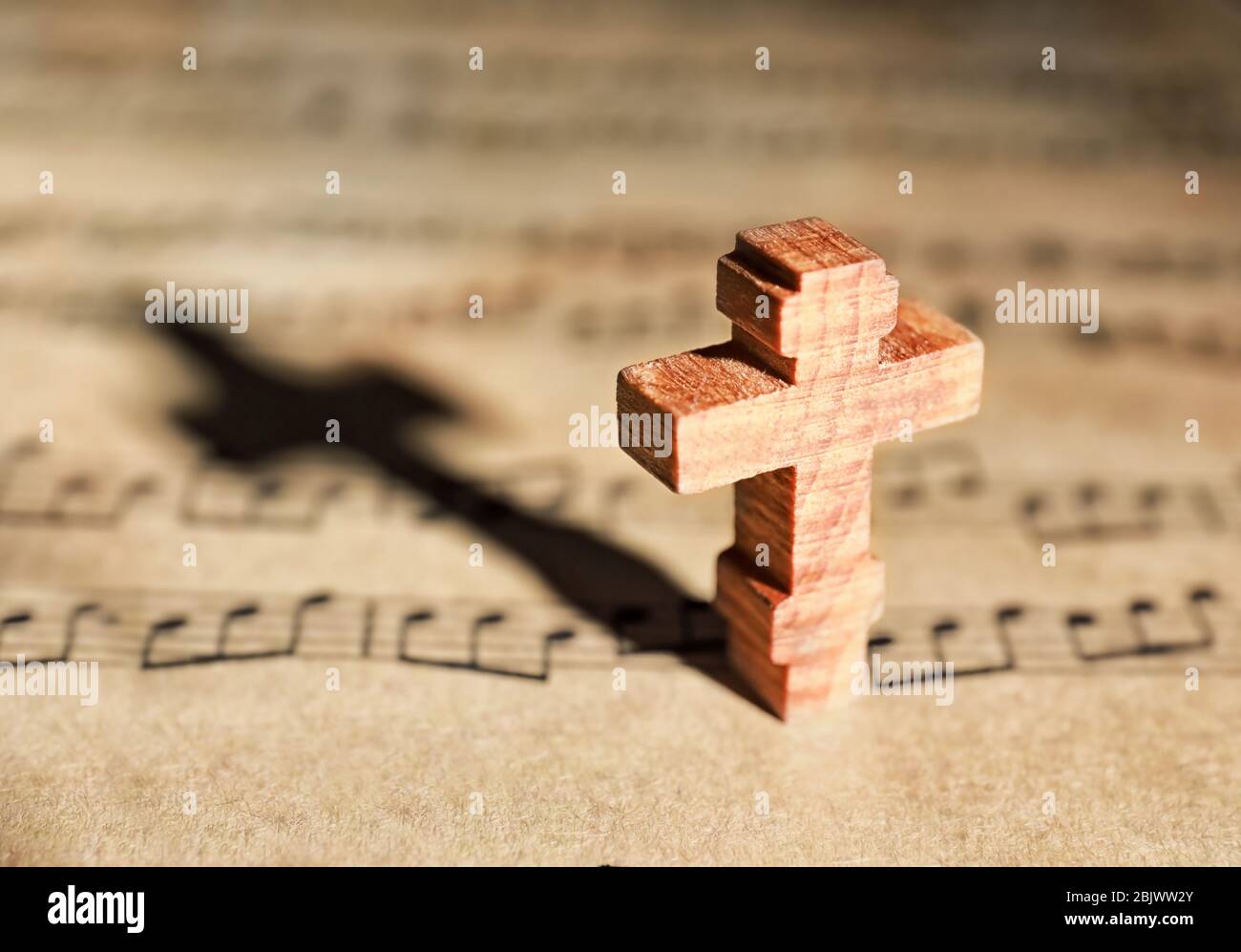 Wooden cross on music sheet Stock Photo - Alamy