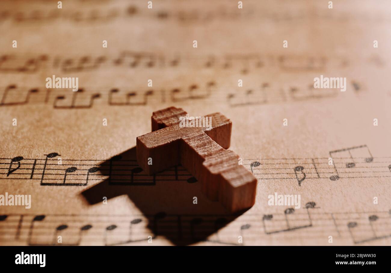 Wooden cross on music sheet Stock Photo - Alamy