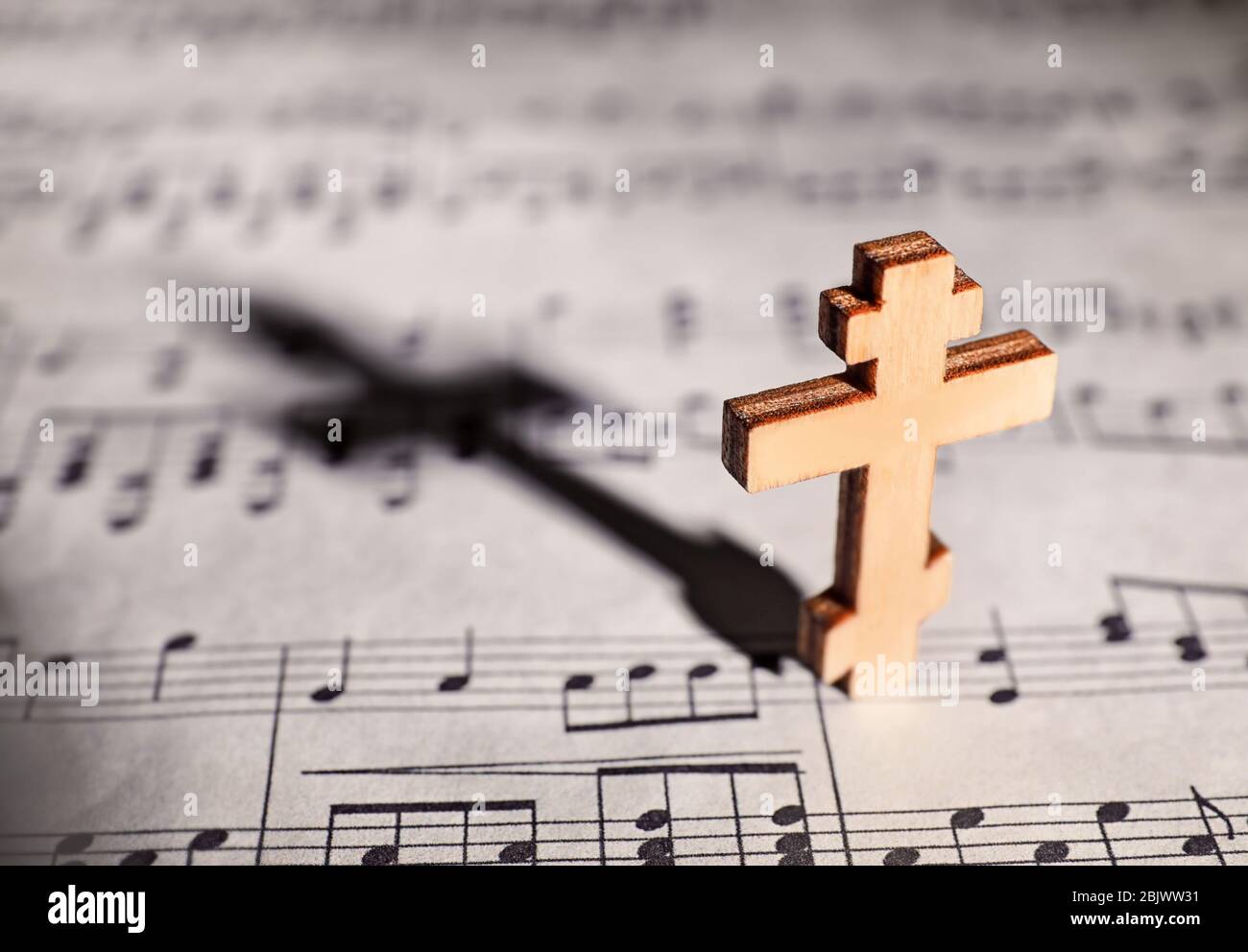 Wooden cross on music sheet Stock Photo - Alamy