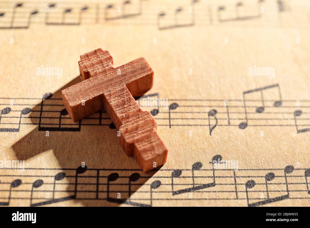 Wooden cross on music sheet Stock Photo - Alamy