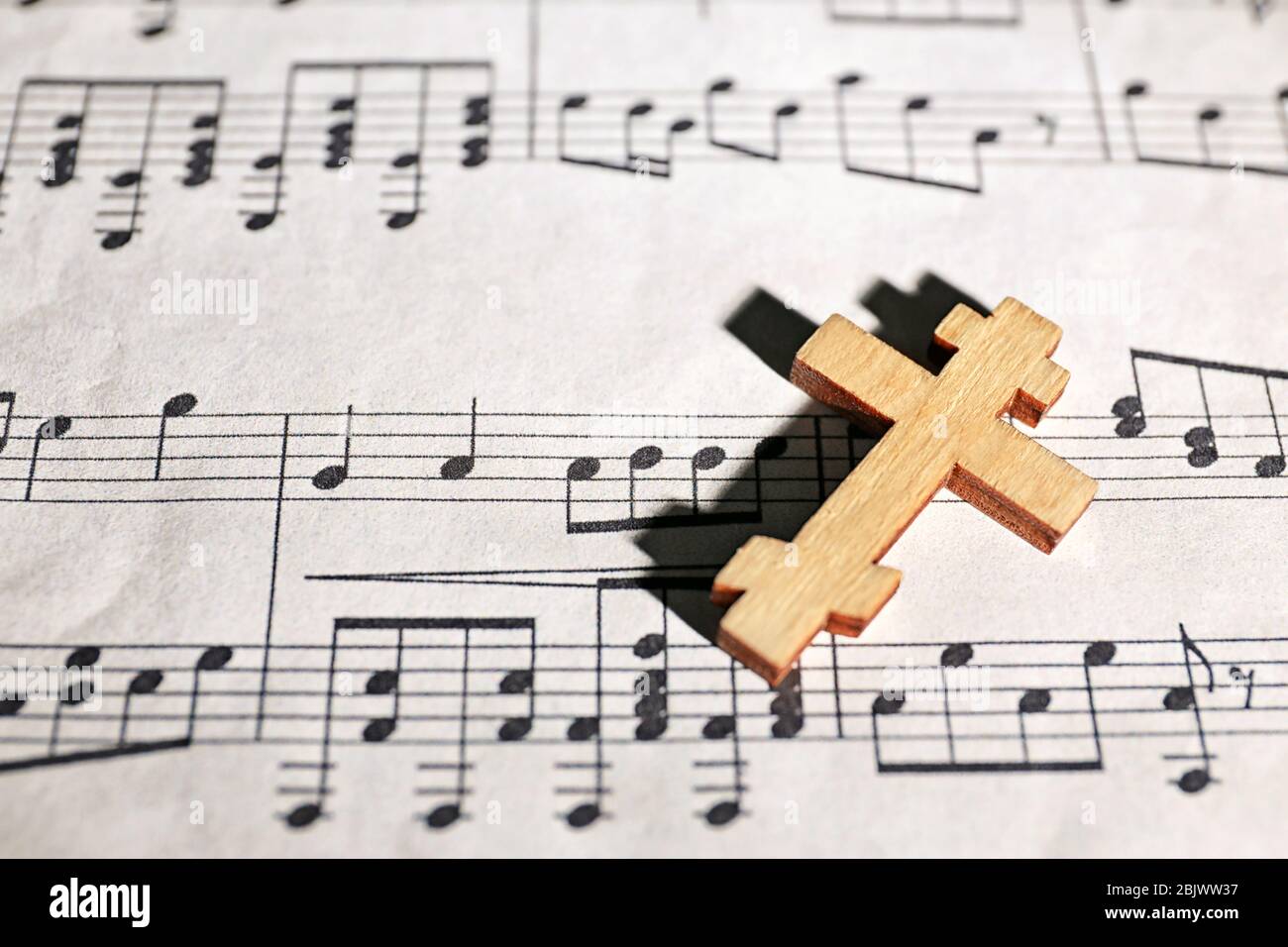 Wooden cross on music sheet Stock Photo - Alamy
