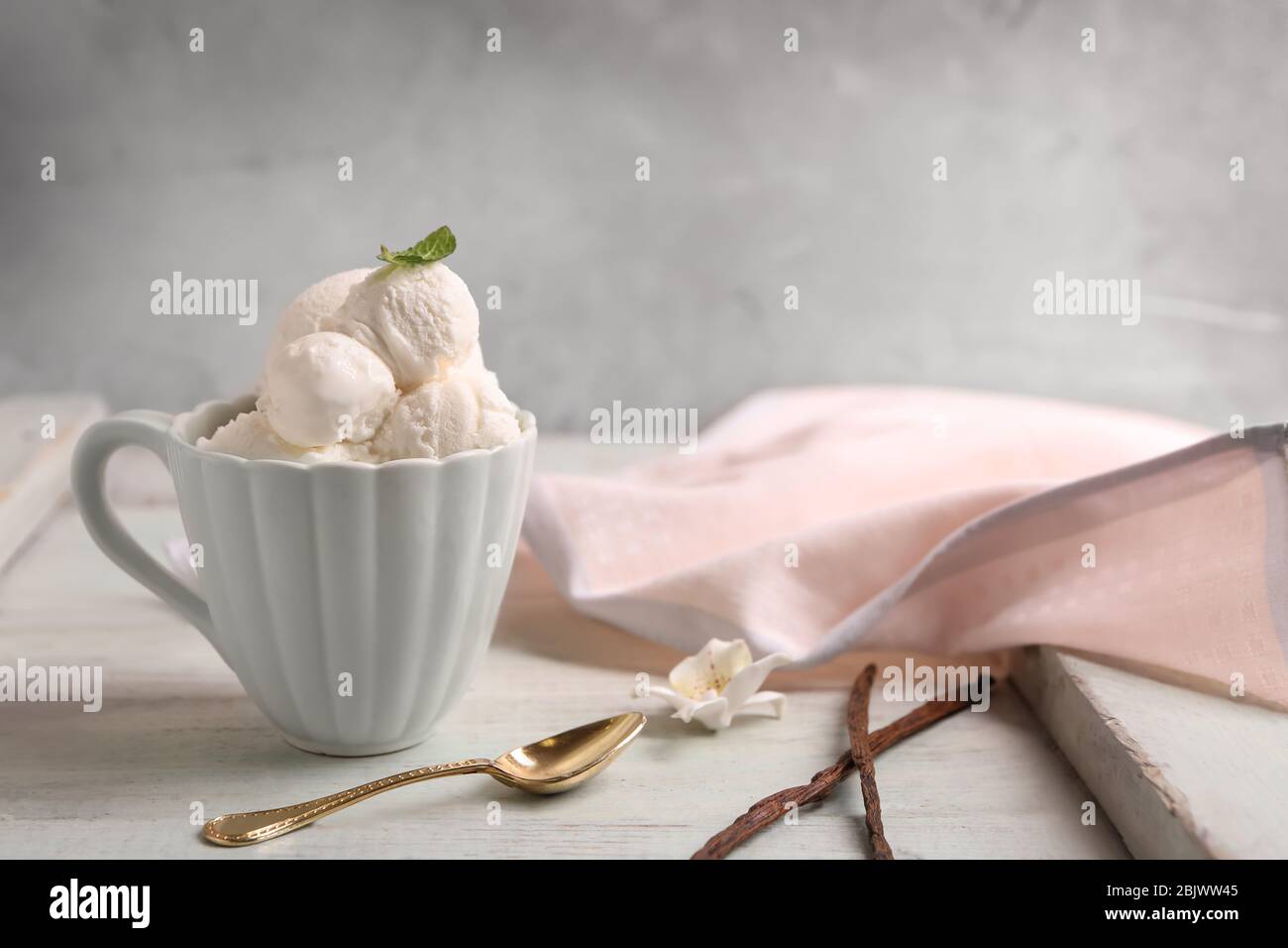 Cup with delicious vanilla ice cream on table Stock Photo - Alamy