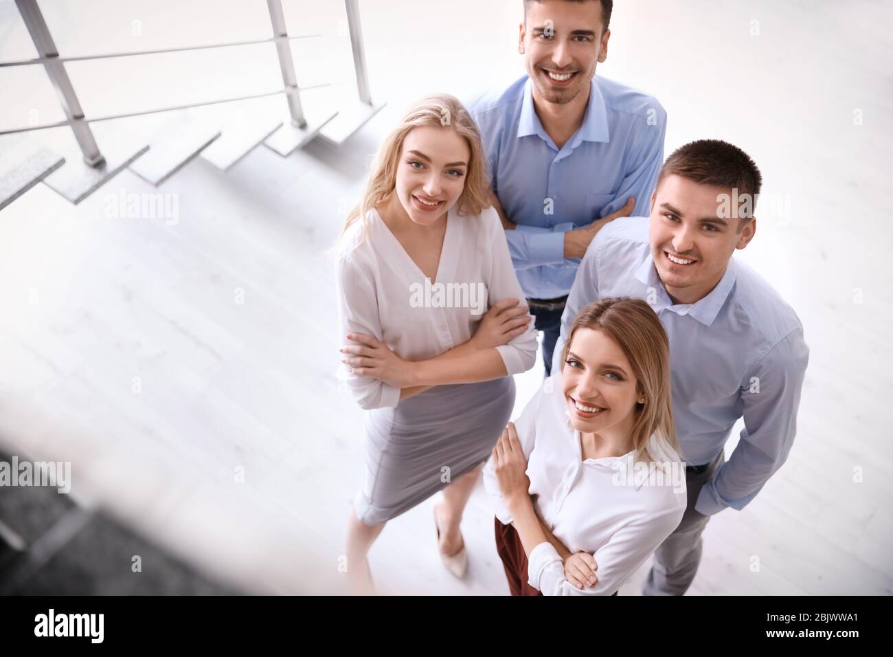 Young office employees indoors. Unity concept Stock Photo - Alamy