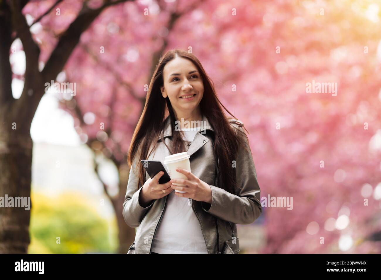 Outdoor portrait of young beautiful fashionable lady posing near ...