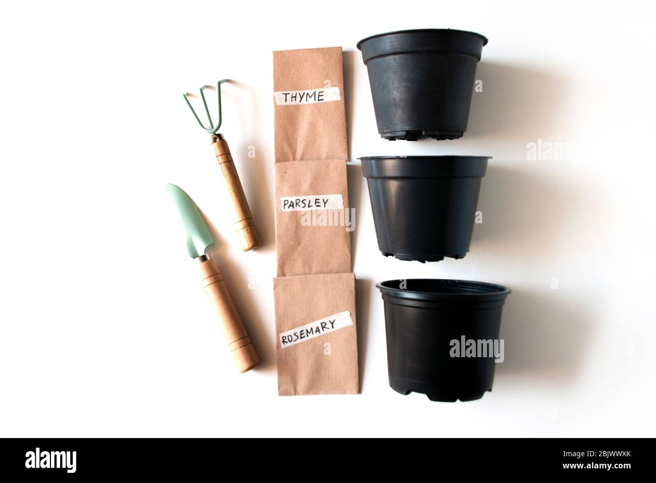 Home garden suplies, small shovel and rake, plastic pots for seedlings ...