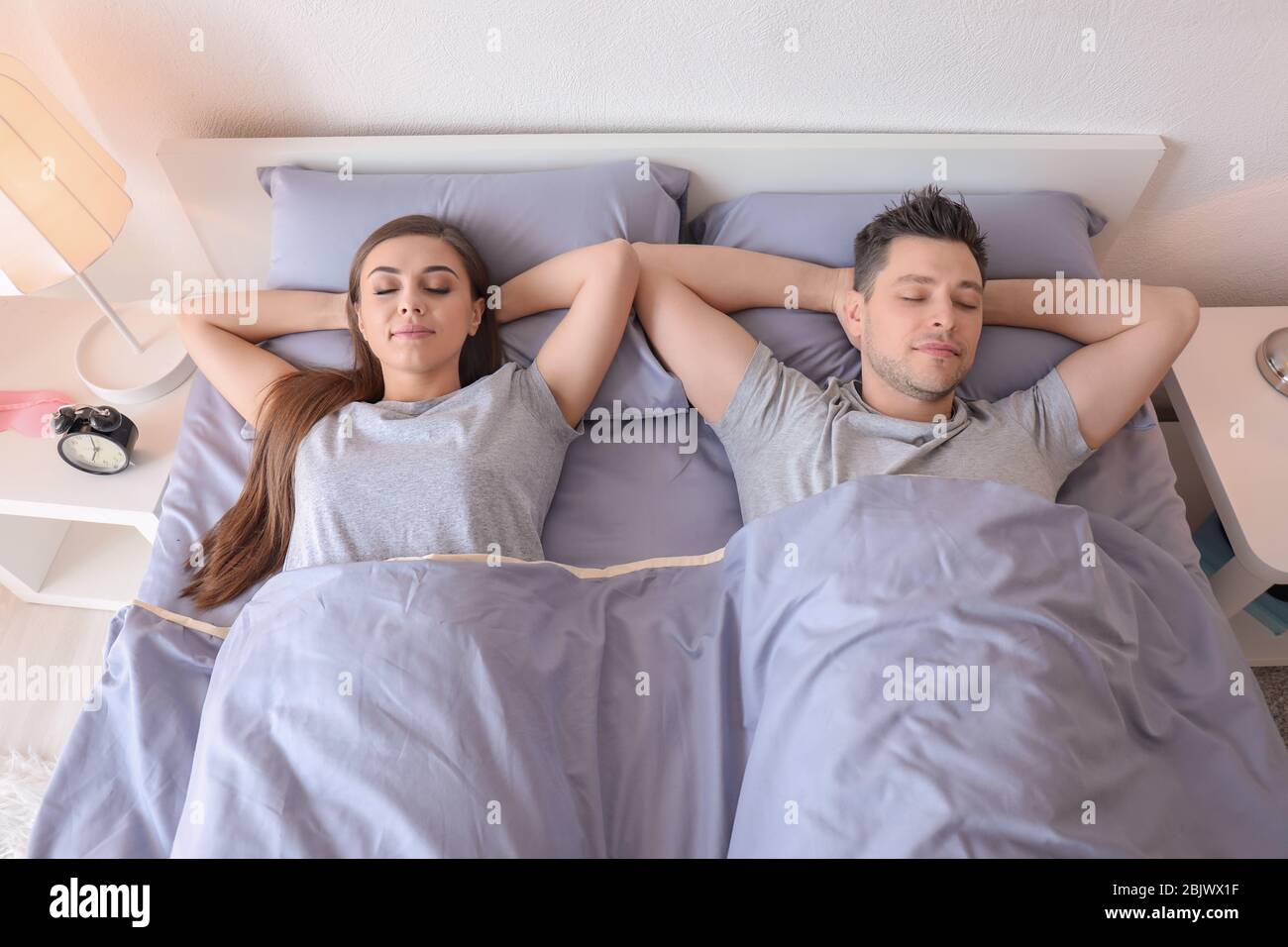 Young couple sleeping in bed at home. Family bedtime Stock Photo - Alamy